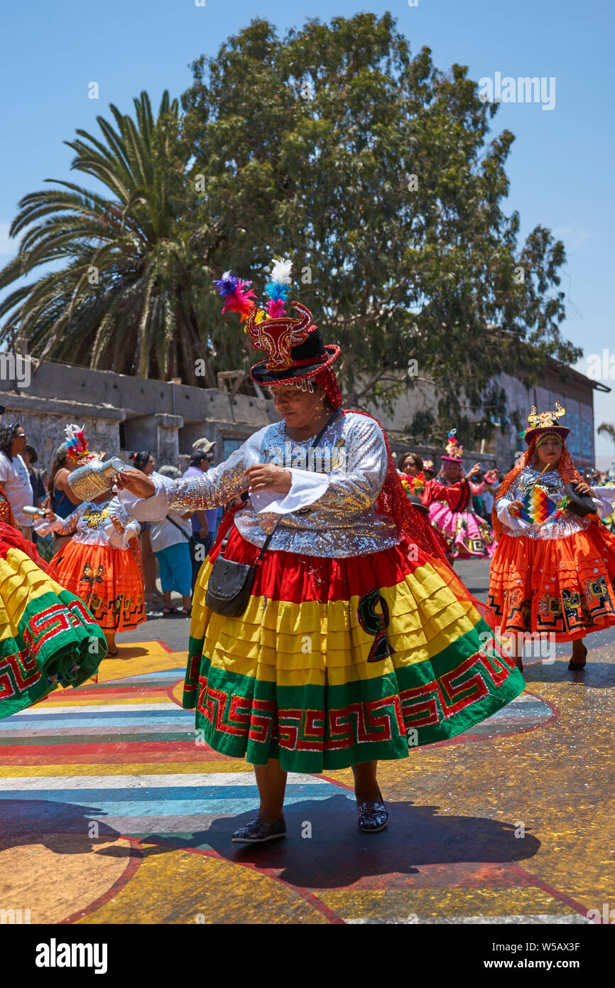 Members of a Waca Waca dance group in ornate costume performing at the ...