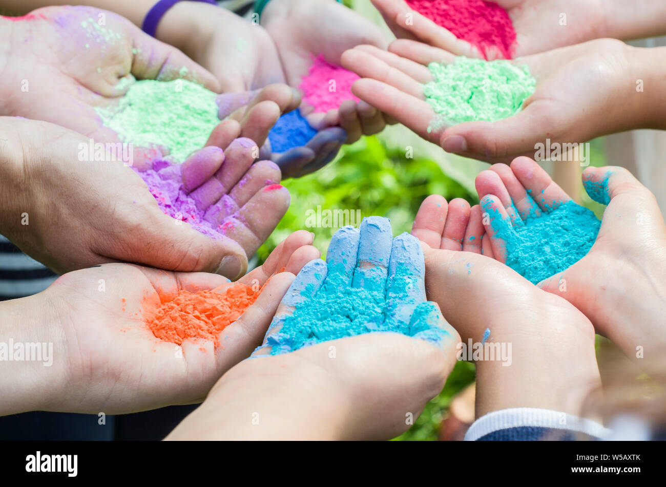 Holly powder paint in the palms. Art therapy photo Stock Photo - Alamy