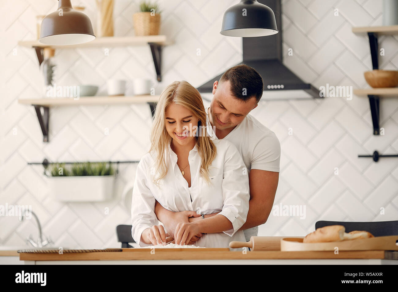 Beautiful couple prepare food in a kitchen Stock Photo - Alamy
