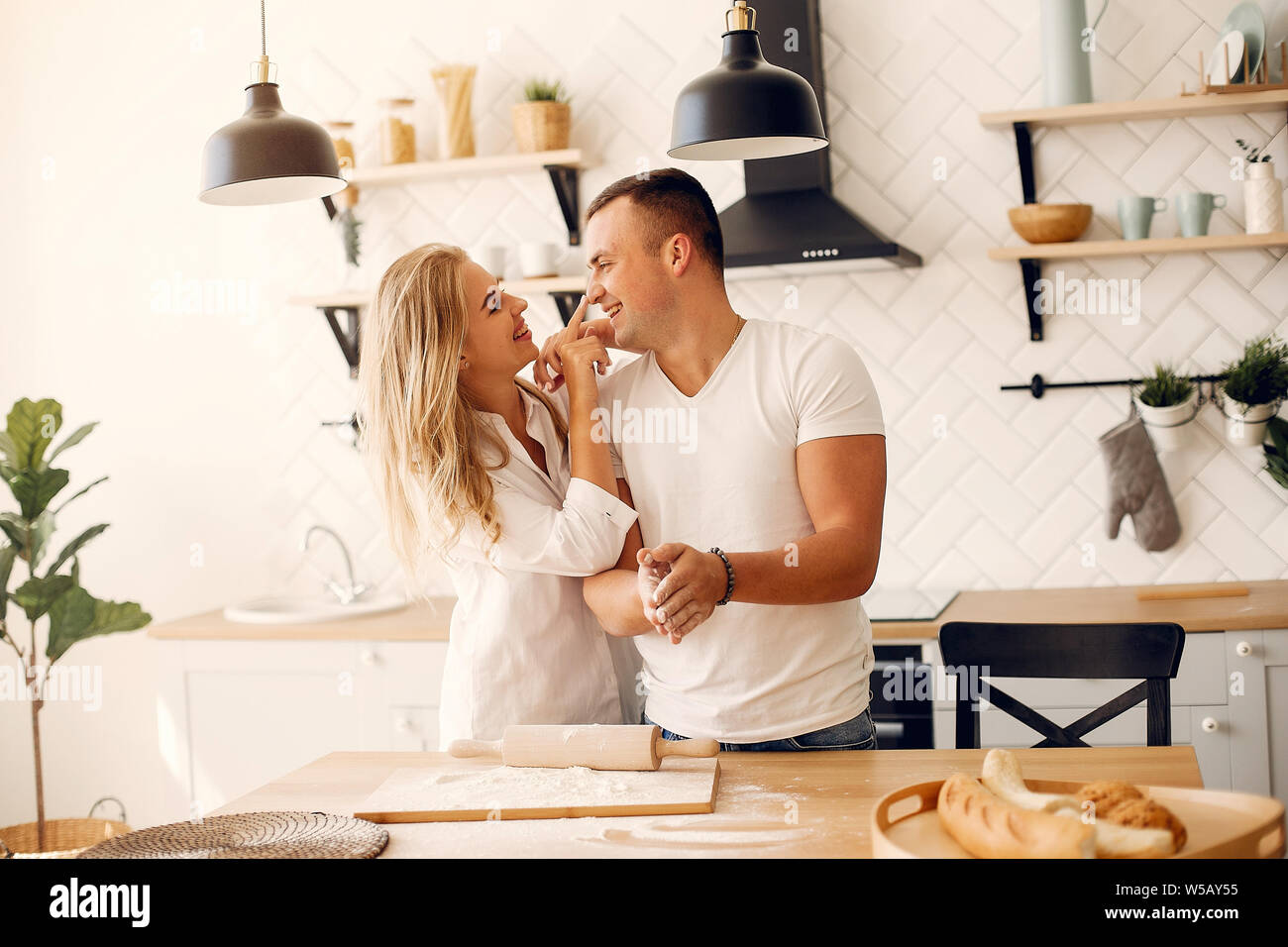 Beautiful couple prepare food in a kitchen Stock Photo - Alamy