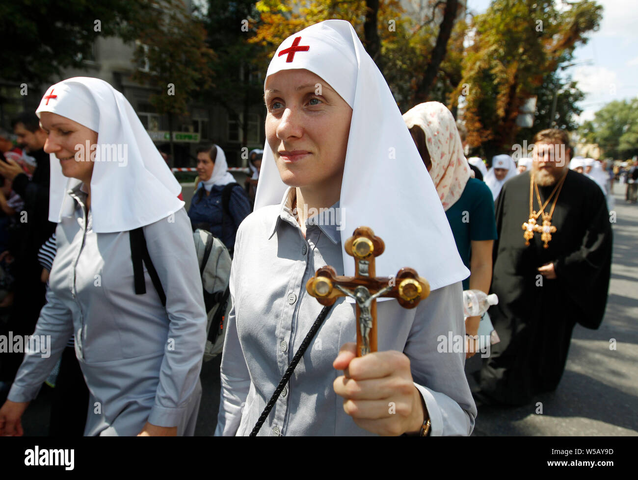 Orthodox nun carries a crucifixion cross during the procession.Orthodox ...