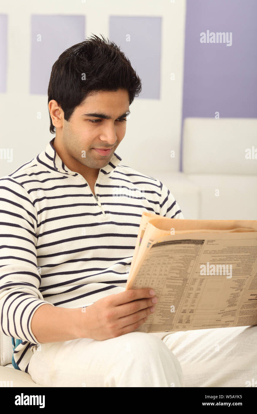 Man reading a newspaper Stock Photo - Alamy