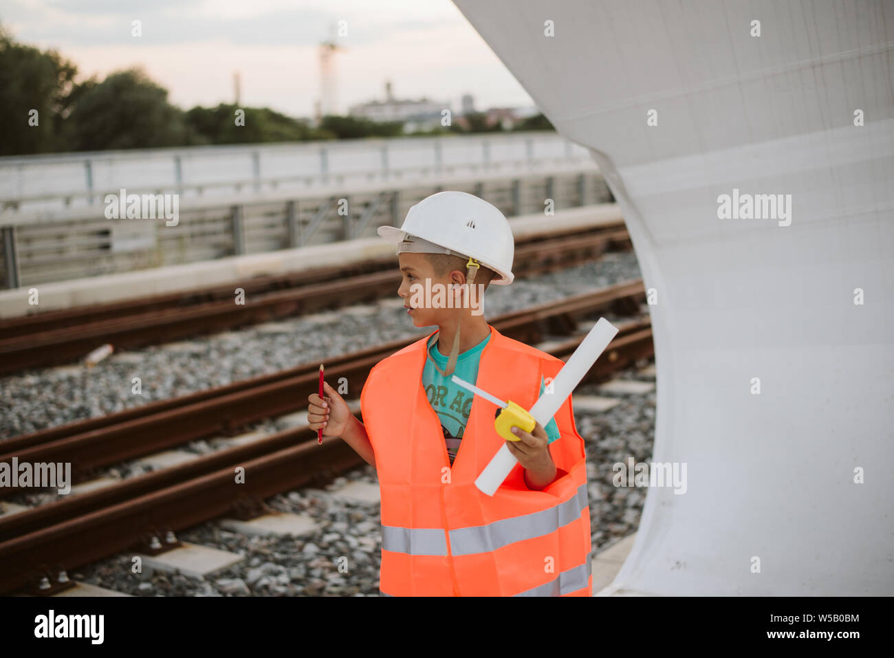 Cute boy engineer on bridge Stock Photo - Alamy