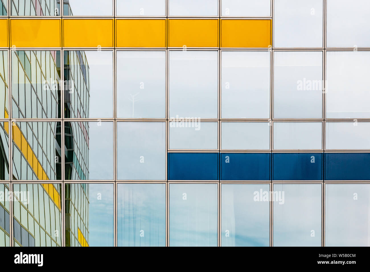 Modern glass office building exterior with colorful details on the ...