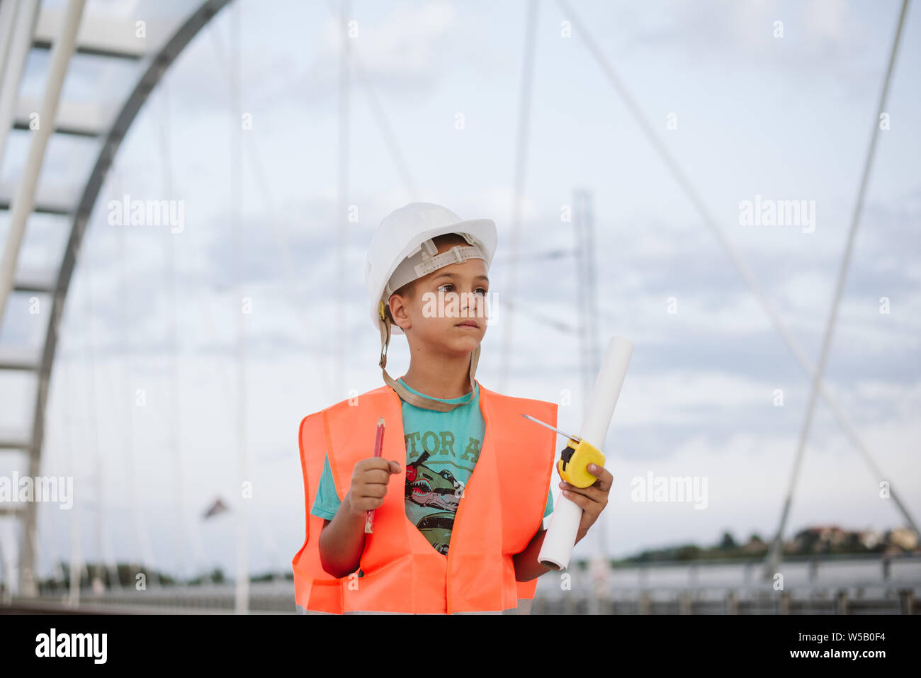 Cute boy engineer on bridge Stock Photo - Alamy
