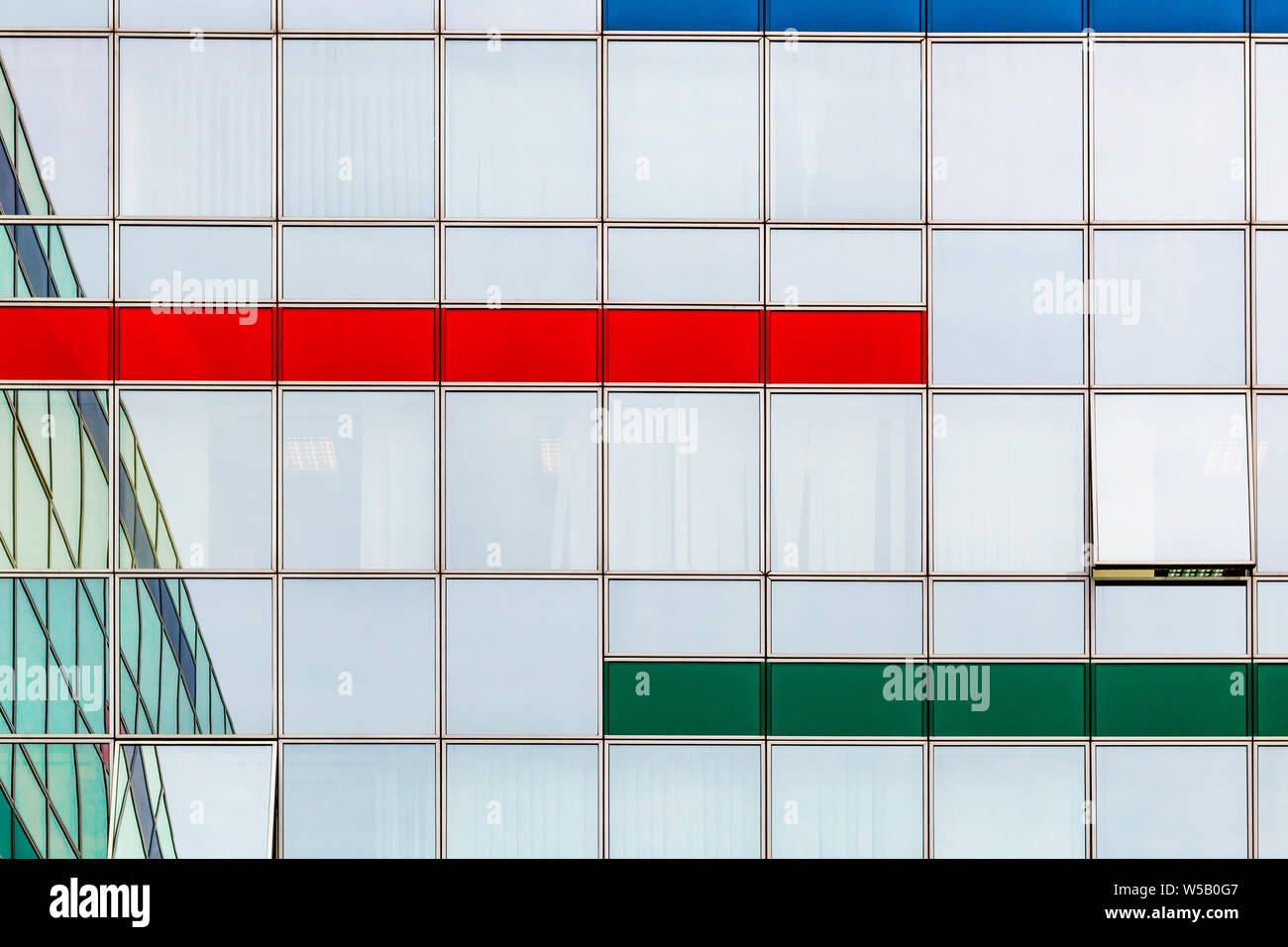 Modern glass office building exterior with colorful details on the ...