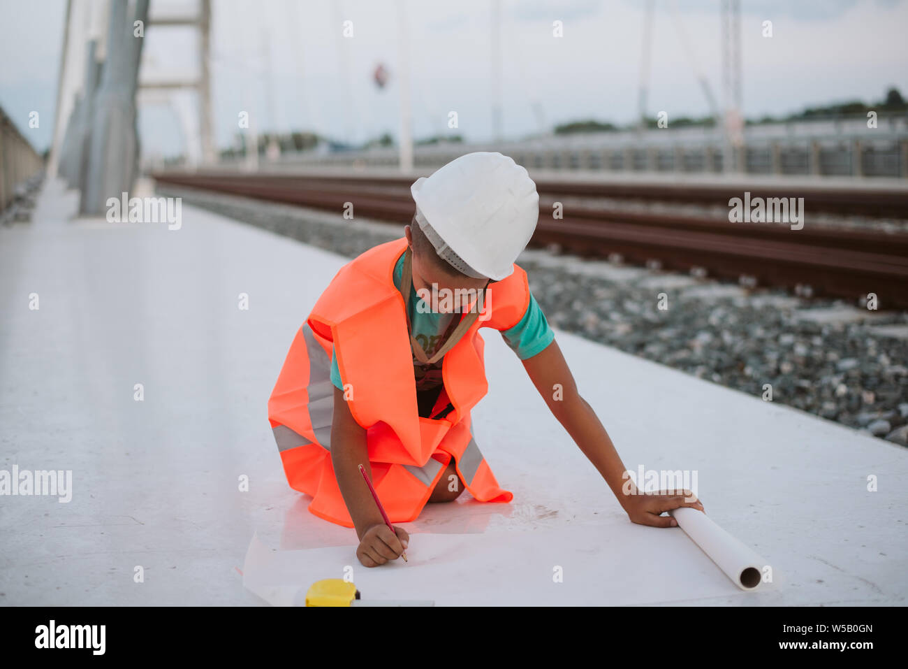 Cute boy engineer on bridge Stock Photo - Alamy