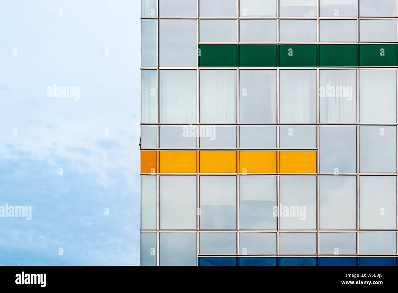 Modern glass office building exterior with colorful details on the ...