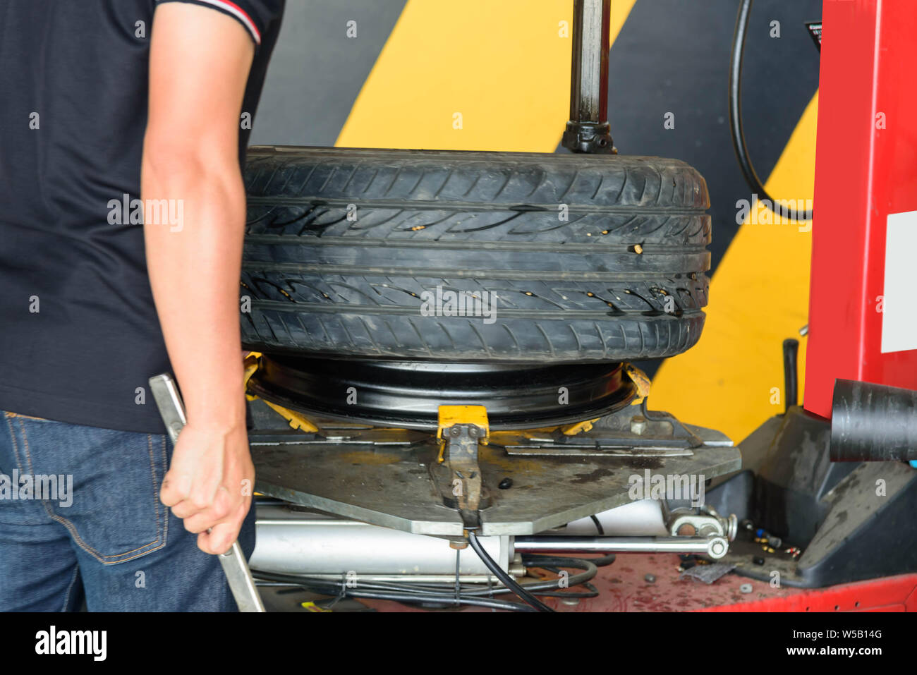 Remove the rubber wheel machine/ Tire changer machine Stock Photo - Alamy