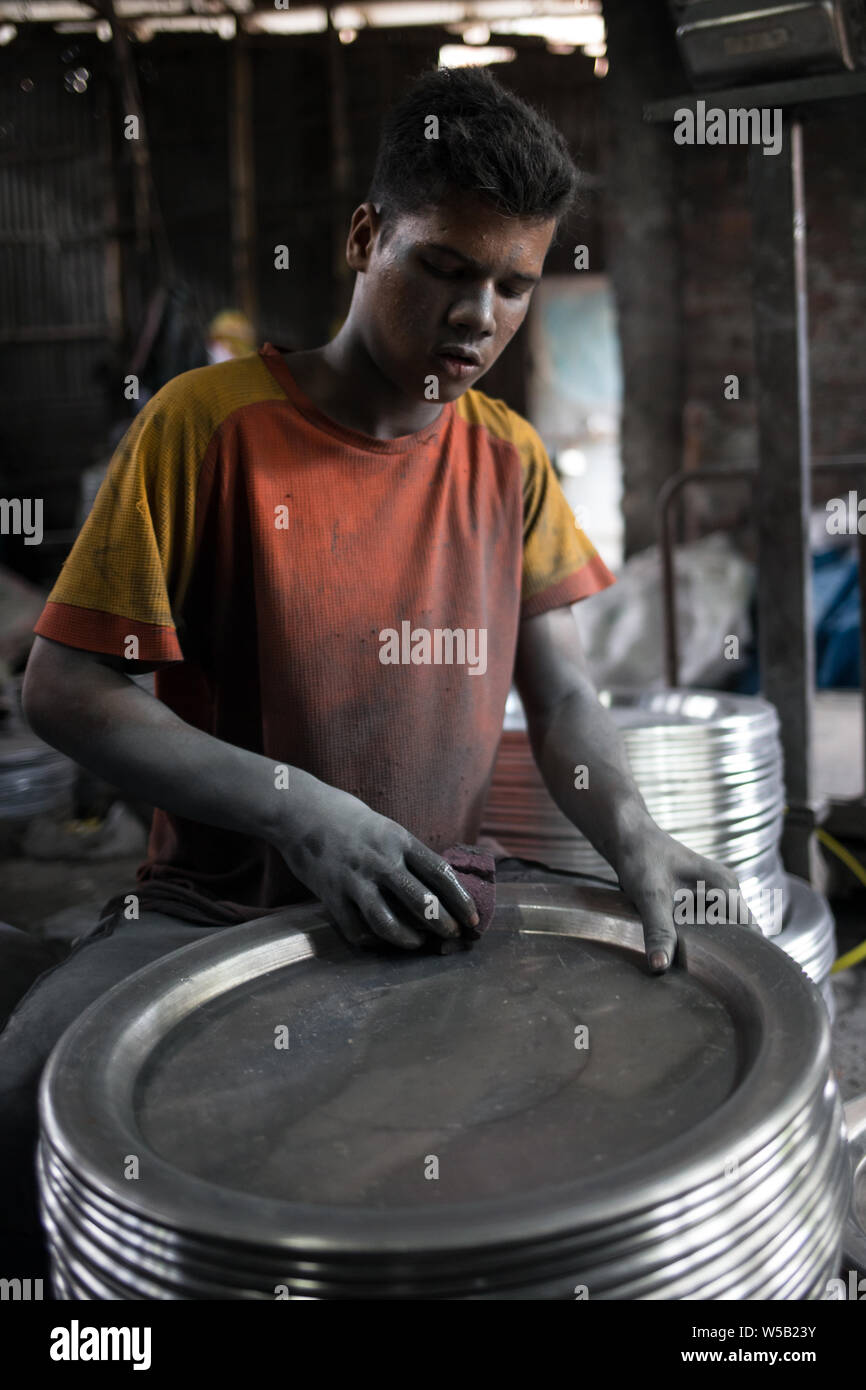 Child Labor - An under age boy working in a silver factory in Dhaka ...
