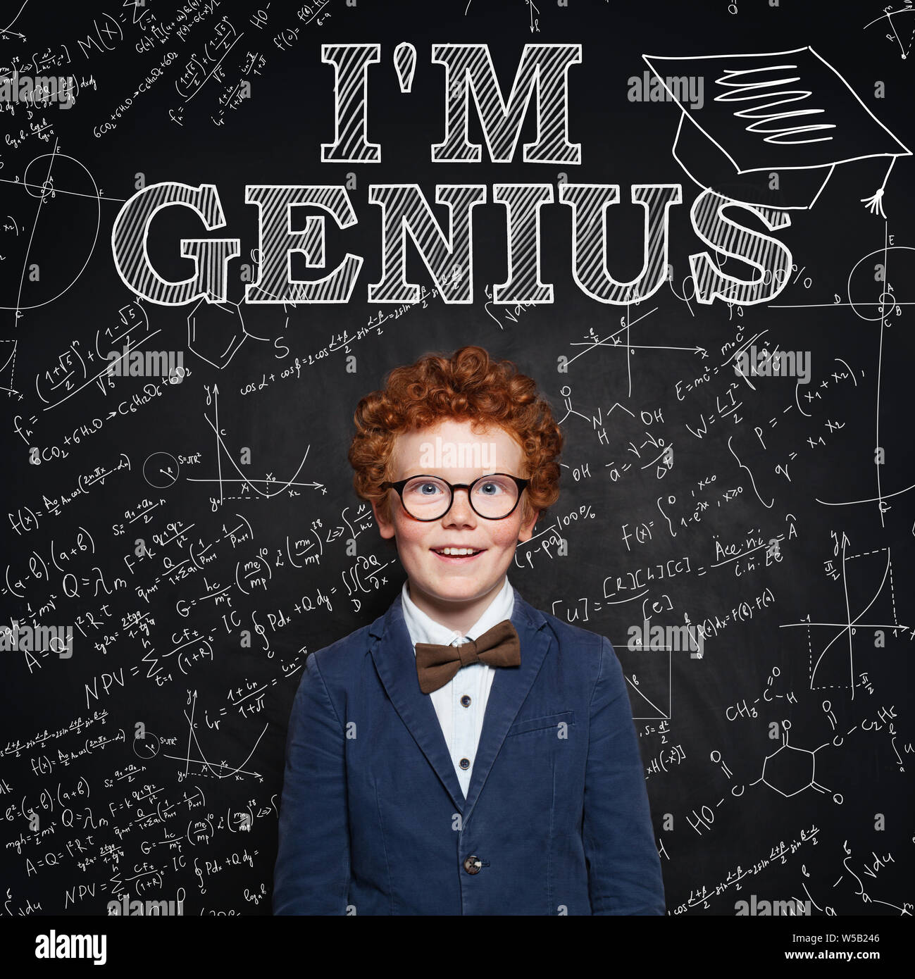 Smart kid boy pupil in student uniform on blackboard background ...