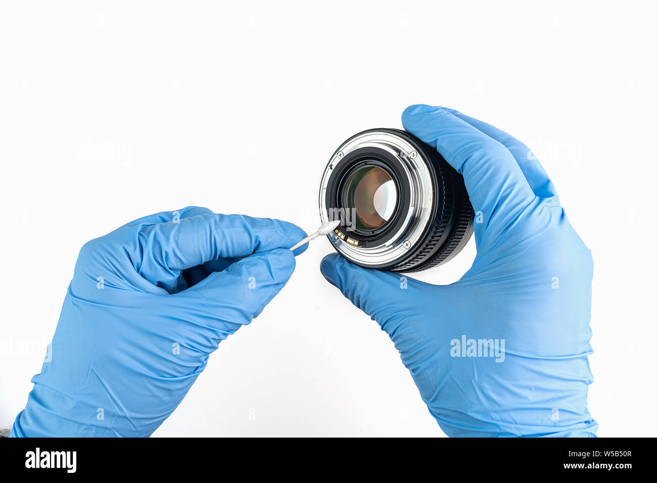 a professional cleaning of a camera lens with a cotton swab and gloves ...