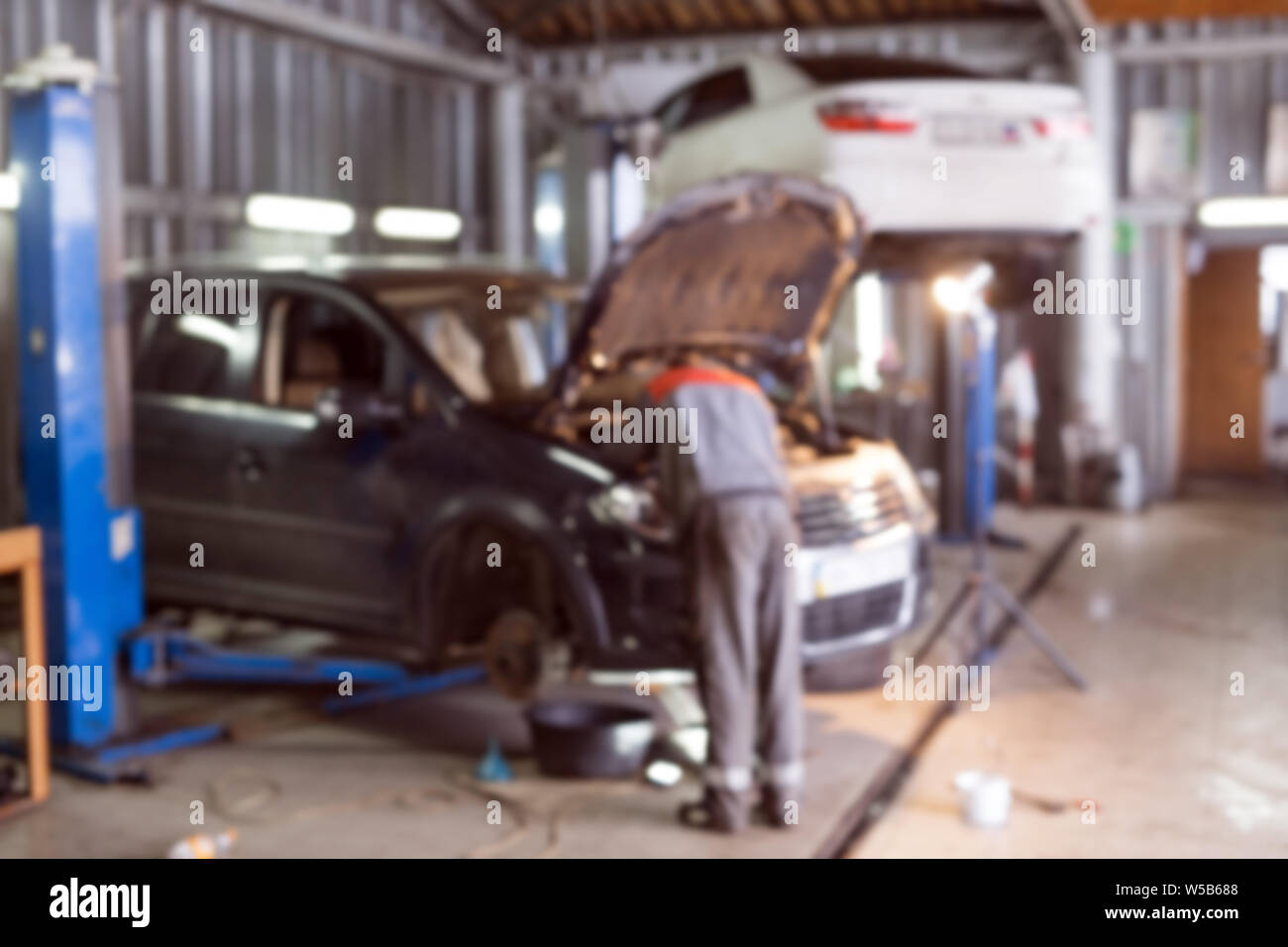 Auto mechanic working in garage. Repair service Stock Photo - Alamy