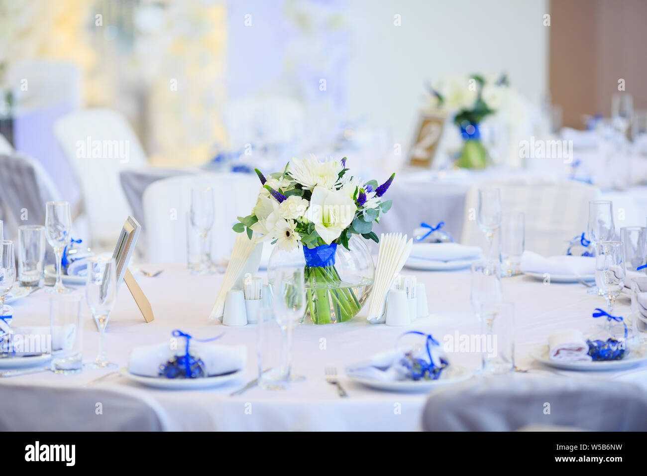 Wedding table setting in the restaurant on the white and blue ...