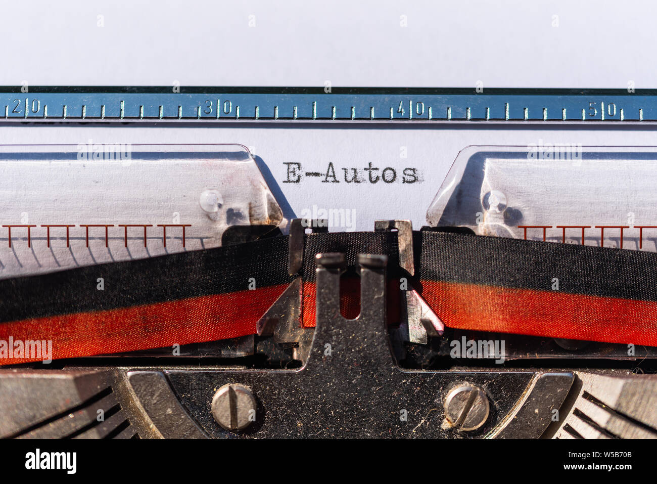 Typewriter with a sheet and the text E-Autos (E-cars Stock Photo - Alamy