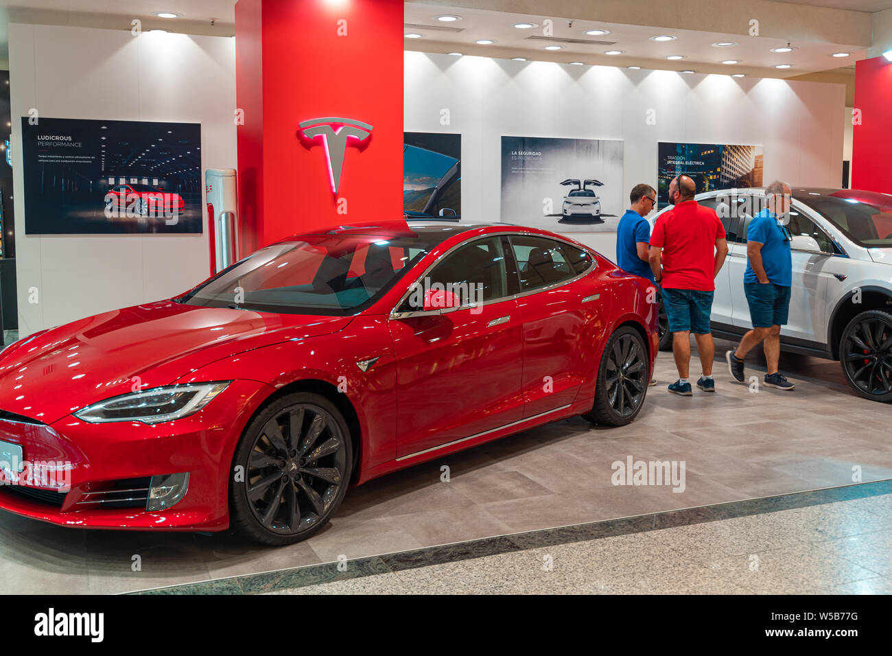 Valencia, Spain - July 21, 2019: Two buyers of a Tesla Model S electric ...