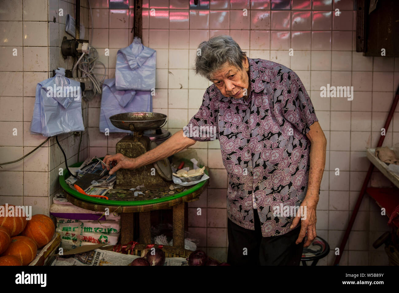 Old woman on her food stall at Fa Yuen market. Hong Kong Stock Photo ...
