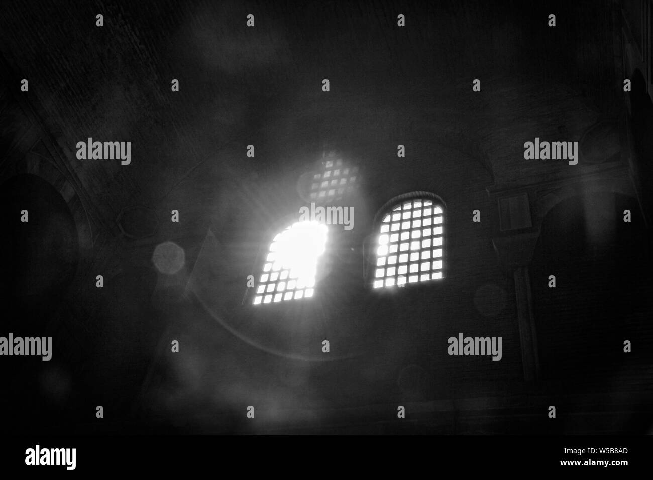 Low angle shot of light shining through a window with metal bars in ...