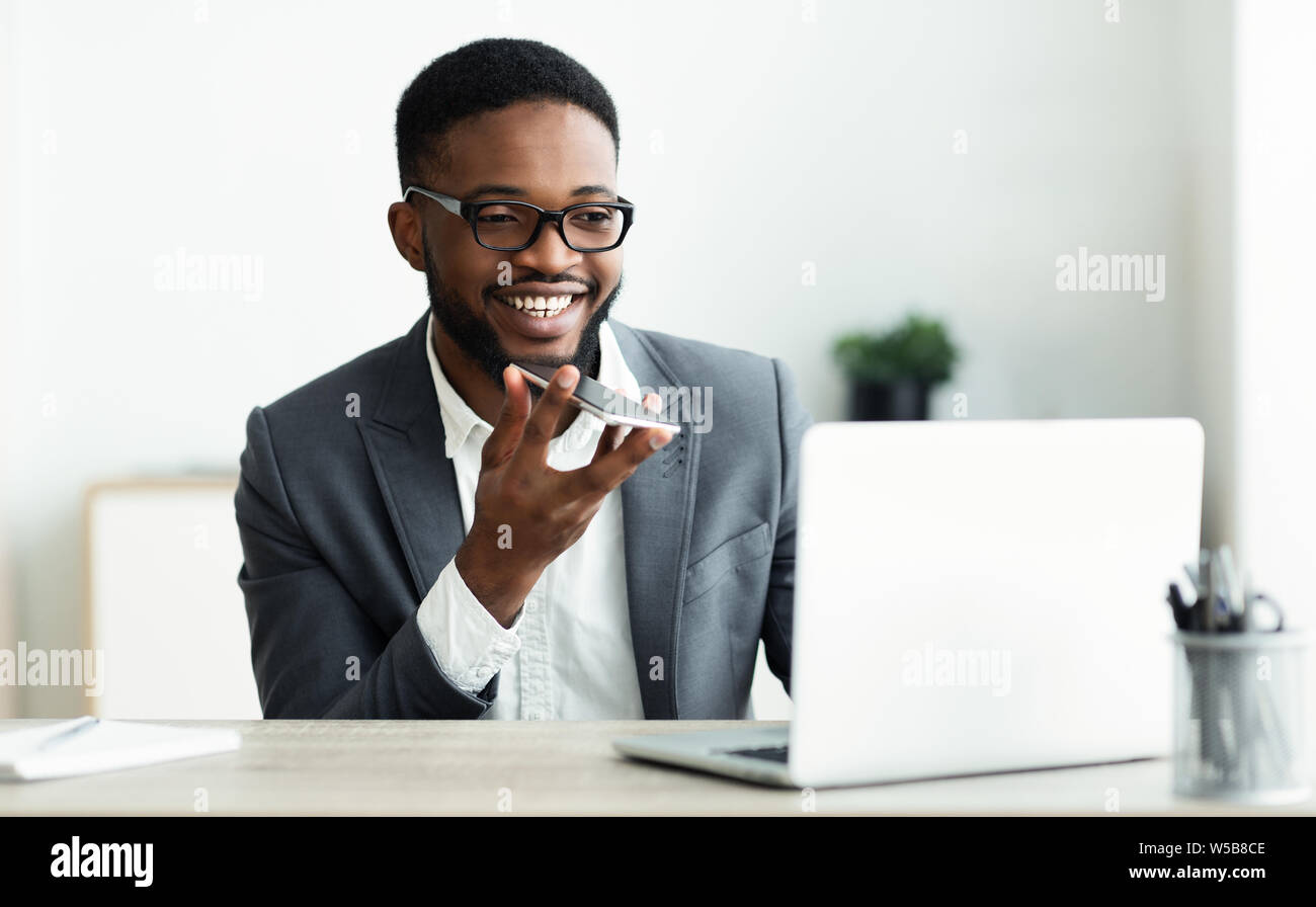 African American businessman using voice assistant on smartphone Stock ...