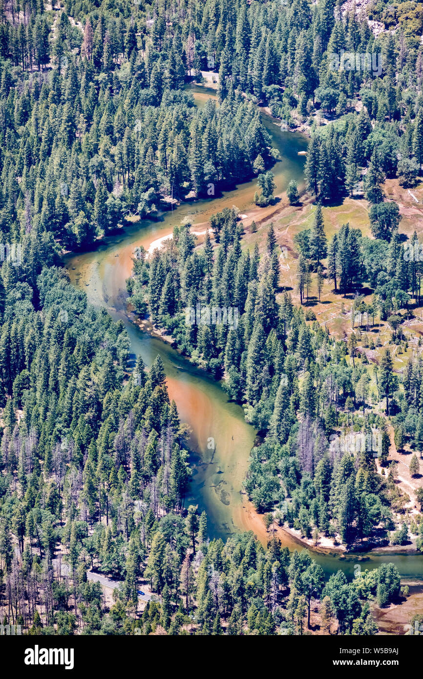Aerial view of Merced river flowing through evergreen forests in ...