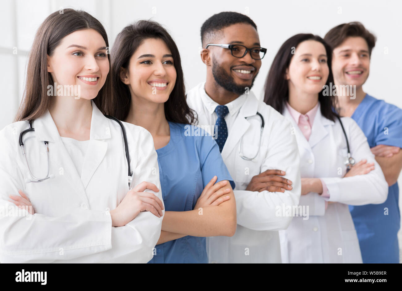 Diverse team of doctors posing in hospital in row Stock Photo - Alamy