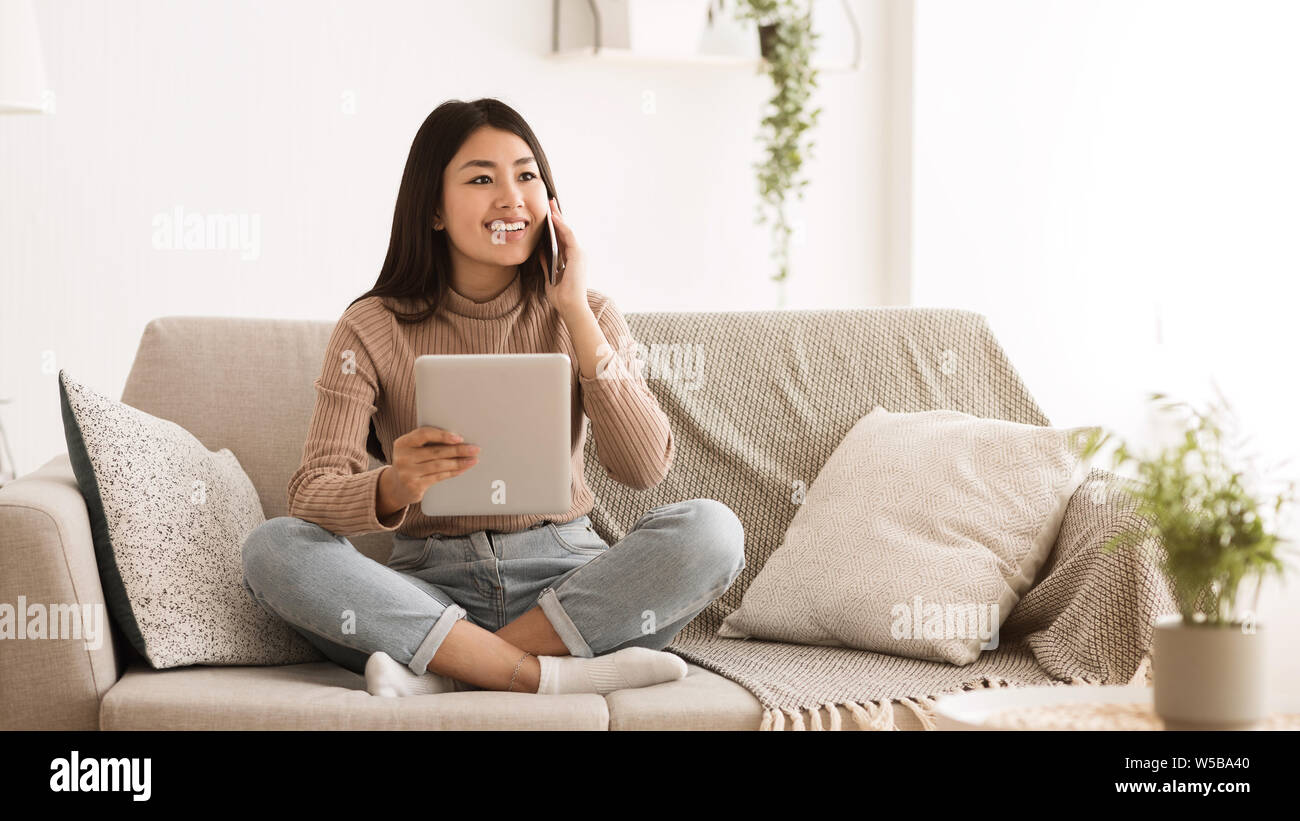 Girl Calling Friend, Using Digital Tablet at Home Stock Photo - Alamy