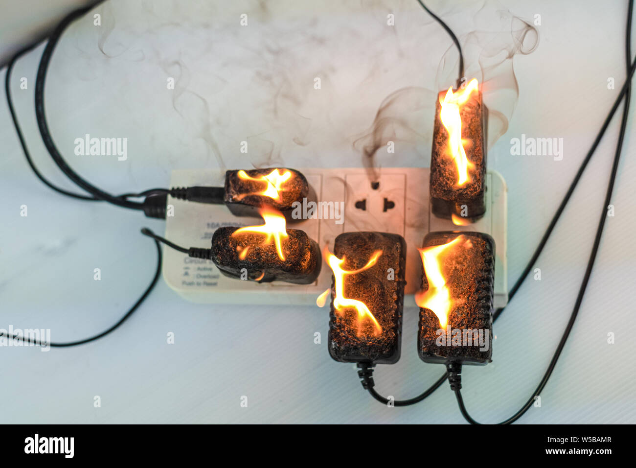 On fire adapter at plug Receptacle on white background, Electric short ...
