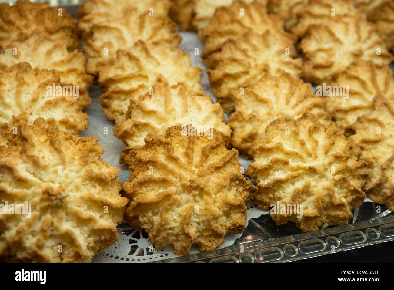Star-shaped coconut macaroon cookies for sale on display in a bakery ...