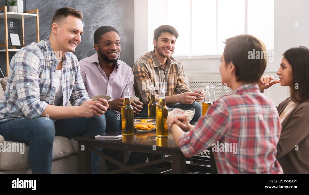 Multiracial friends partying together and playing cards at home Stock ...