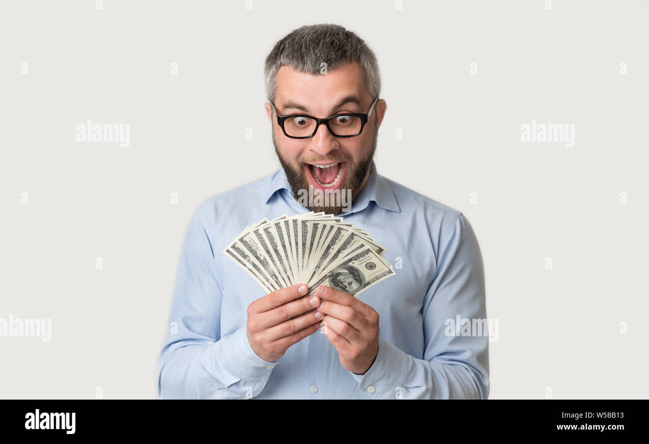 Super happy bearded caucasian man holding money Stock Photo - Alamy