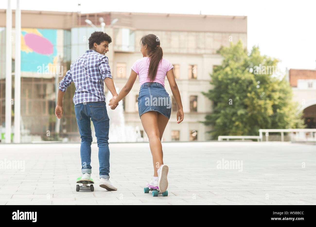 Follow me. Girlfriend following boyfriend holding hand Stock Photo - Alamy