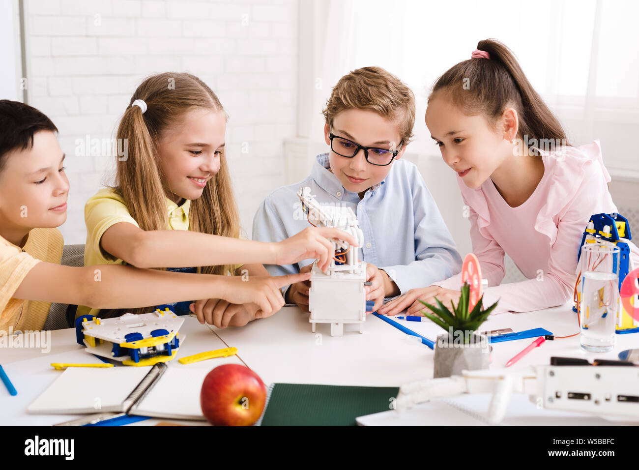 Stem education. Children creating robots at class Stock Photo - Alamy