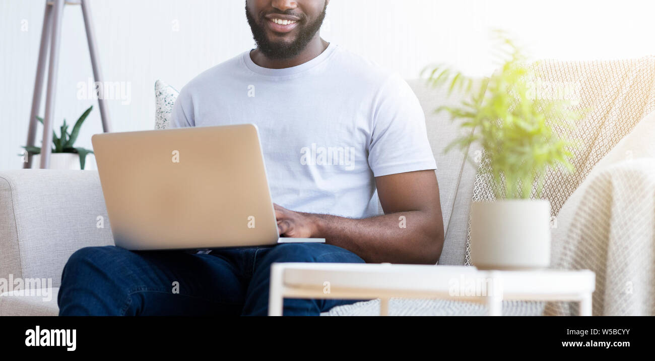 Black man typing text or programming code on laptop Stock Photo - Alamy