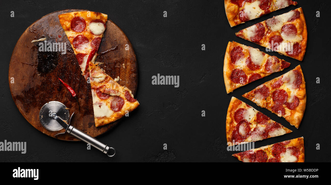 Fresh pepperoni pizza slices in row on dark background Stock Photo - Alamy