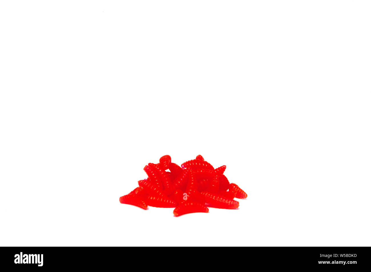 Red Artificial fishing larvae of insects on white background with soft ...