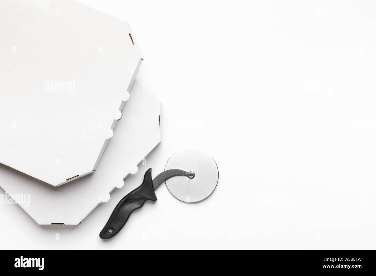 Blank cardboard boxes and pizza cutter on white background Stock Photo ...