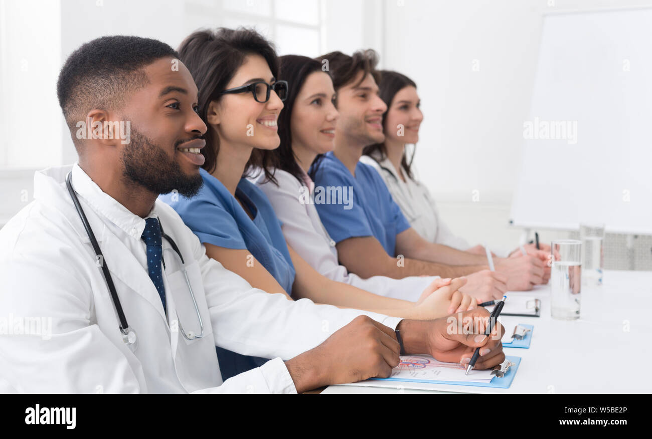 Medical lecture. Doctors and interns listening to professor Stock Photo ...