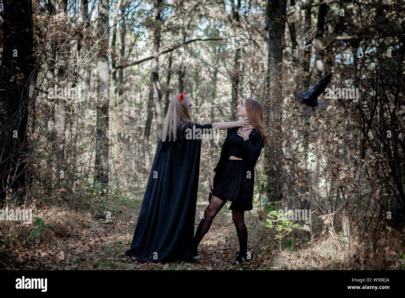 Halloween demon and witch in the woods Stock Photo - Alamy