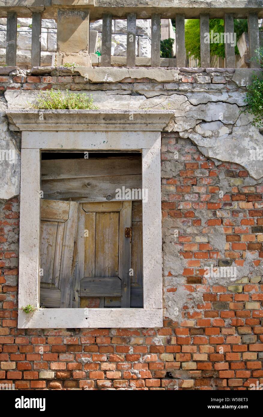 Window of a ruin showing a leaning world Stock Photo - Alamy