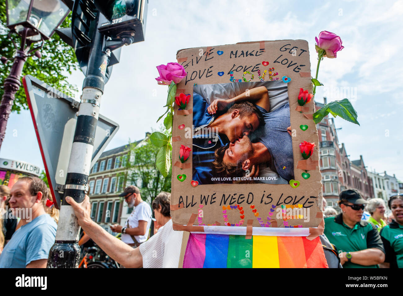 A placard that shows two men kissing during the Pride Walk.Because of ...