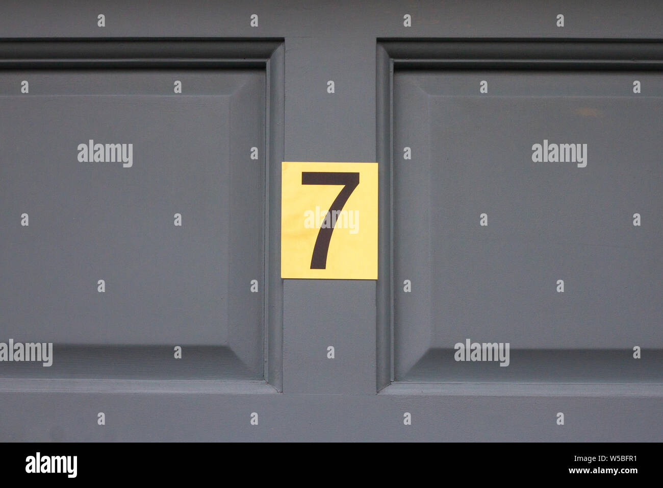 House number 7 on a grey wooden front door Stock Photo - Alamy