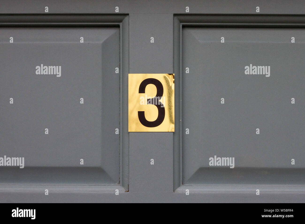 House number 3 on a grey wooden front door Stock Photo - Alamy