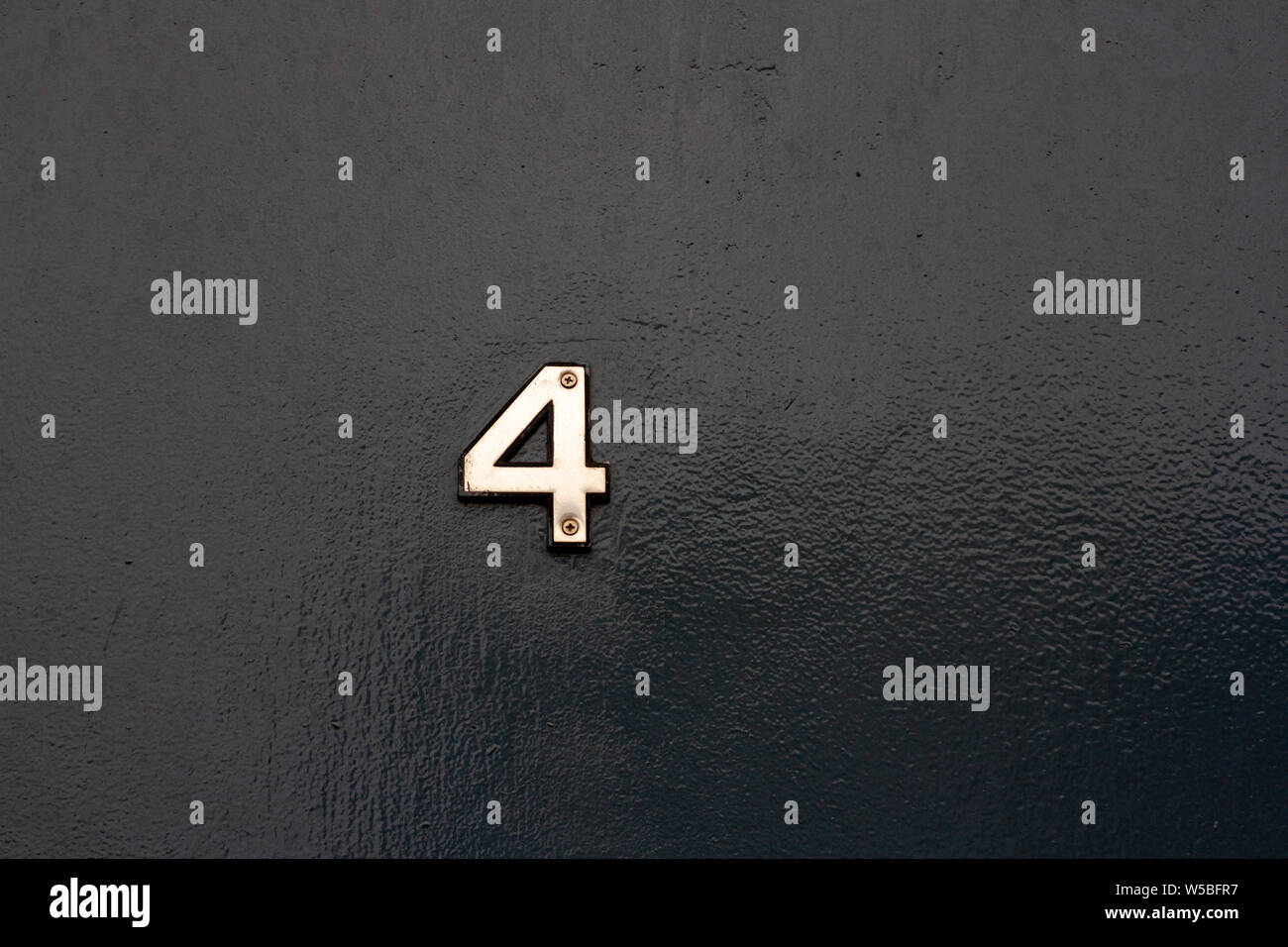 House number 4 on a black font door Stock Photo - Alamy