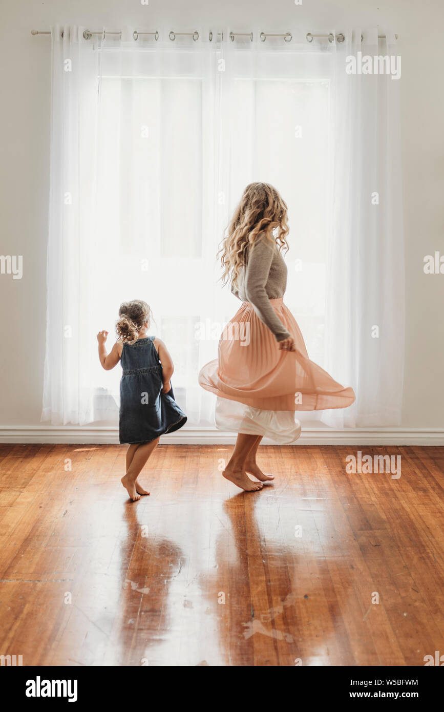 Mother and young daughter dancing in studio Stock Photo - Alamy