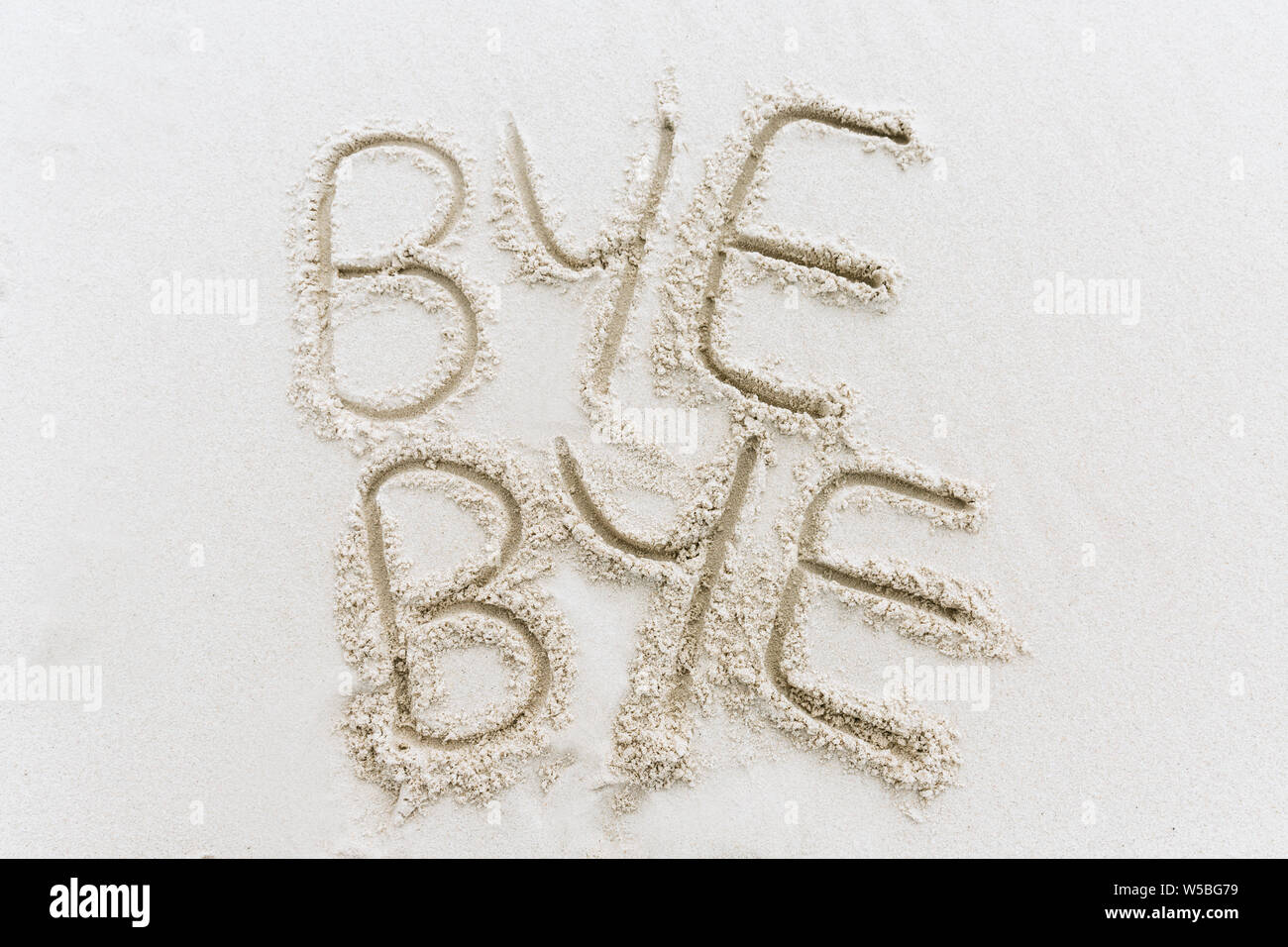 Bye Bye written in sand on white beach Stock Photo - Alamy
