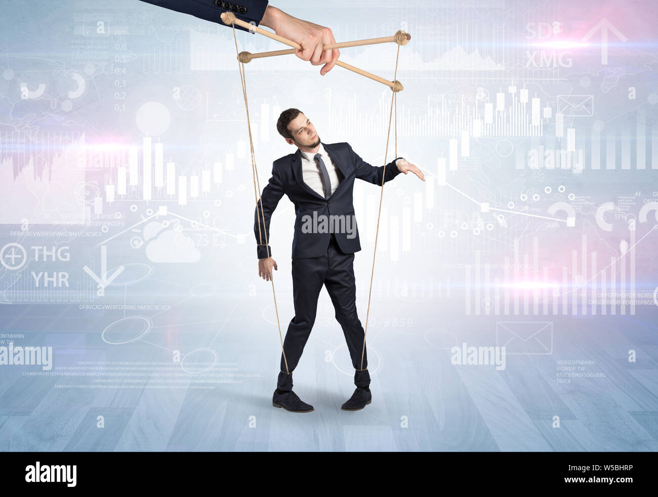 Puppet businessman controlled by another hand with financial concept ...