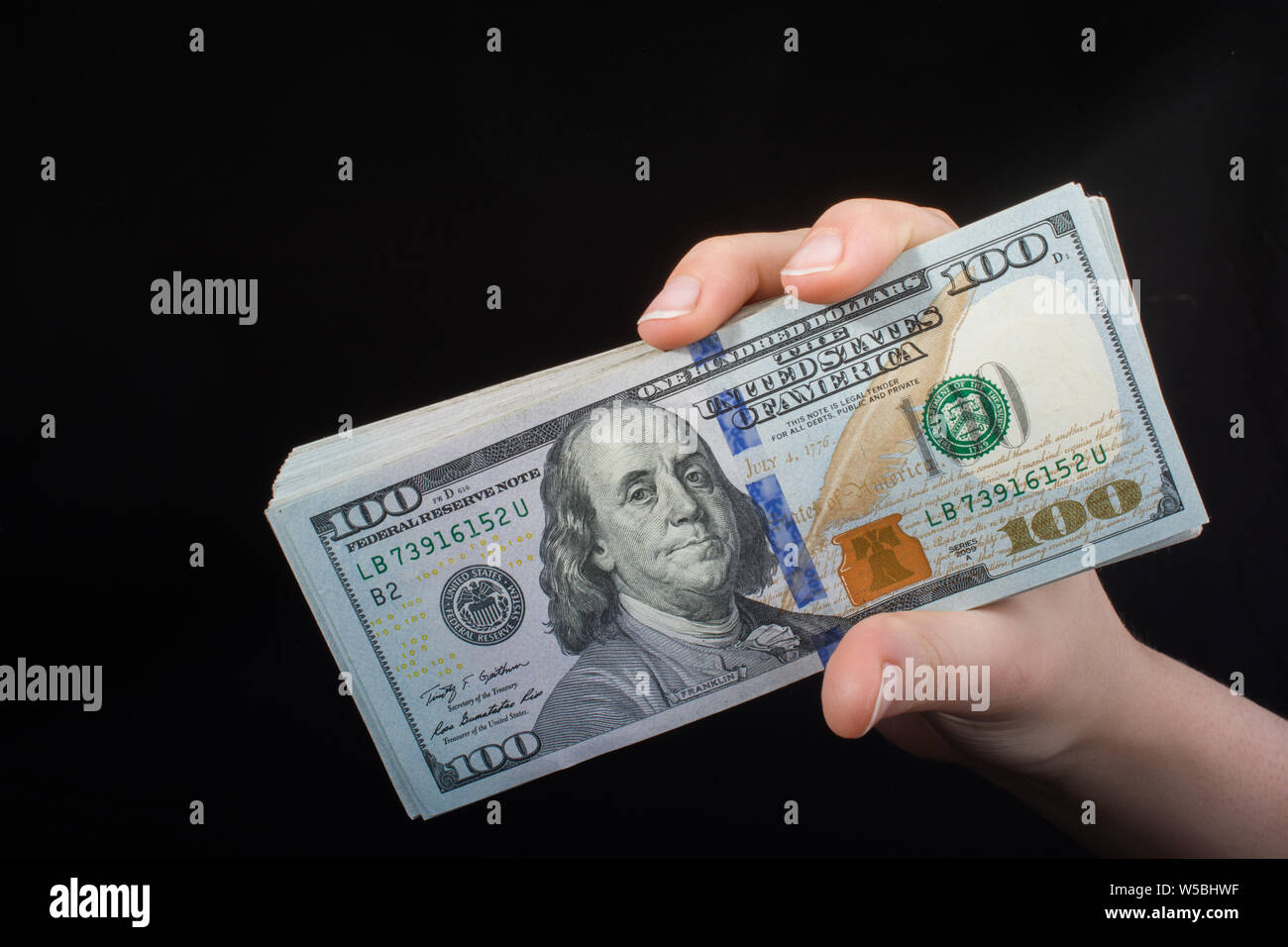 Hand holding American dollar banknotes isolated on white background ...