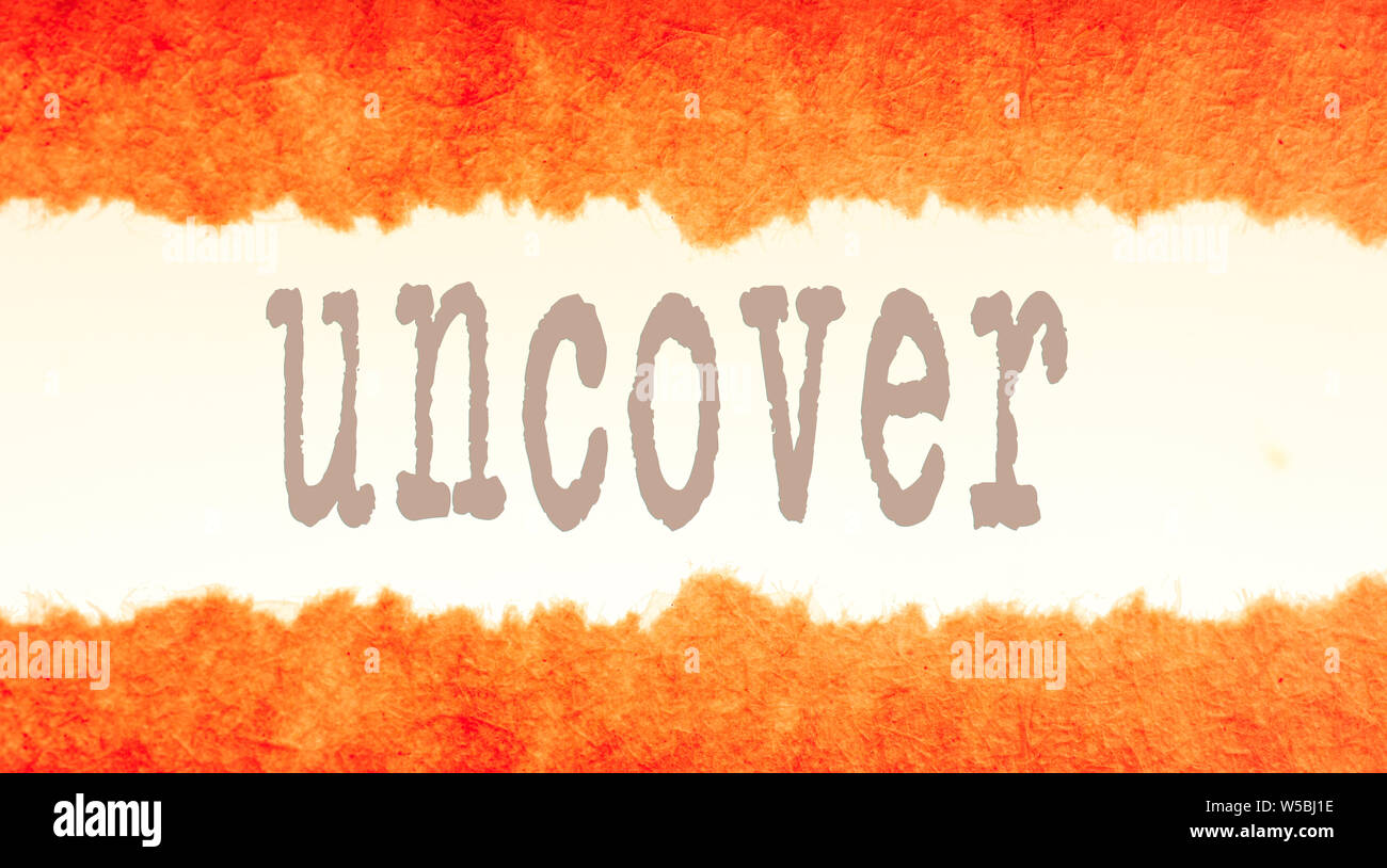 Word UNCOVER and piece of yellow turn paper placed on a white ...