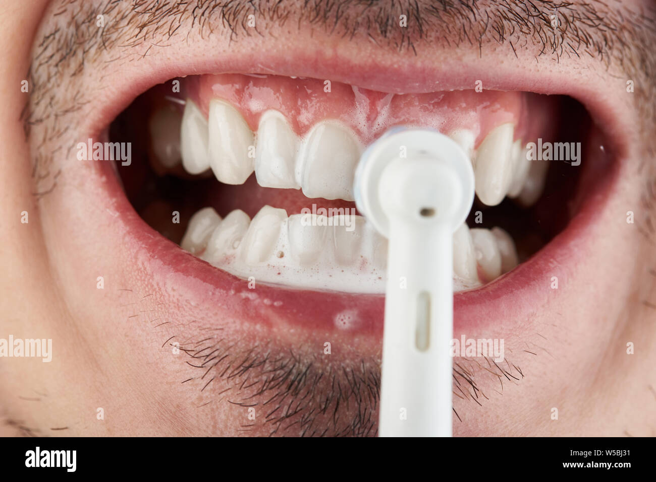 Whitening teeth theme. Brushing teeth close up view Stock Photo - Alamy