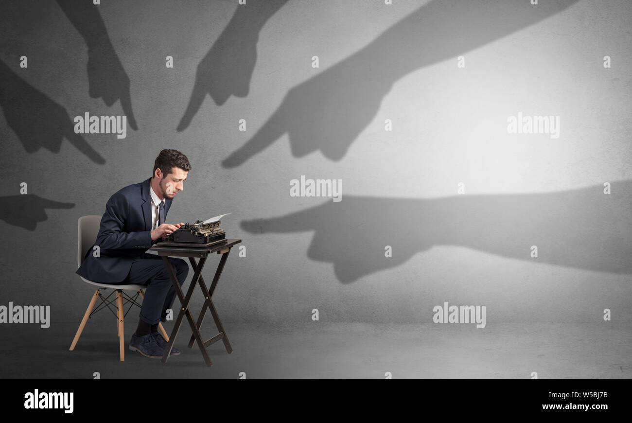 Shadow hand pointing at a small afraid worker Stock Photo - Alamy